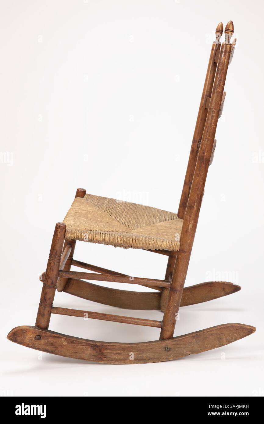 This German-American style child's wooden slat-back rocking chair uses ...
