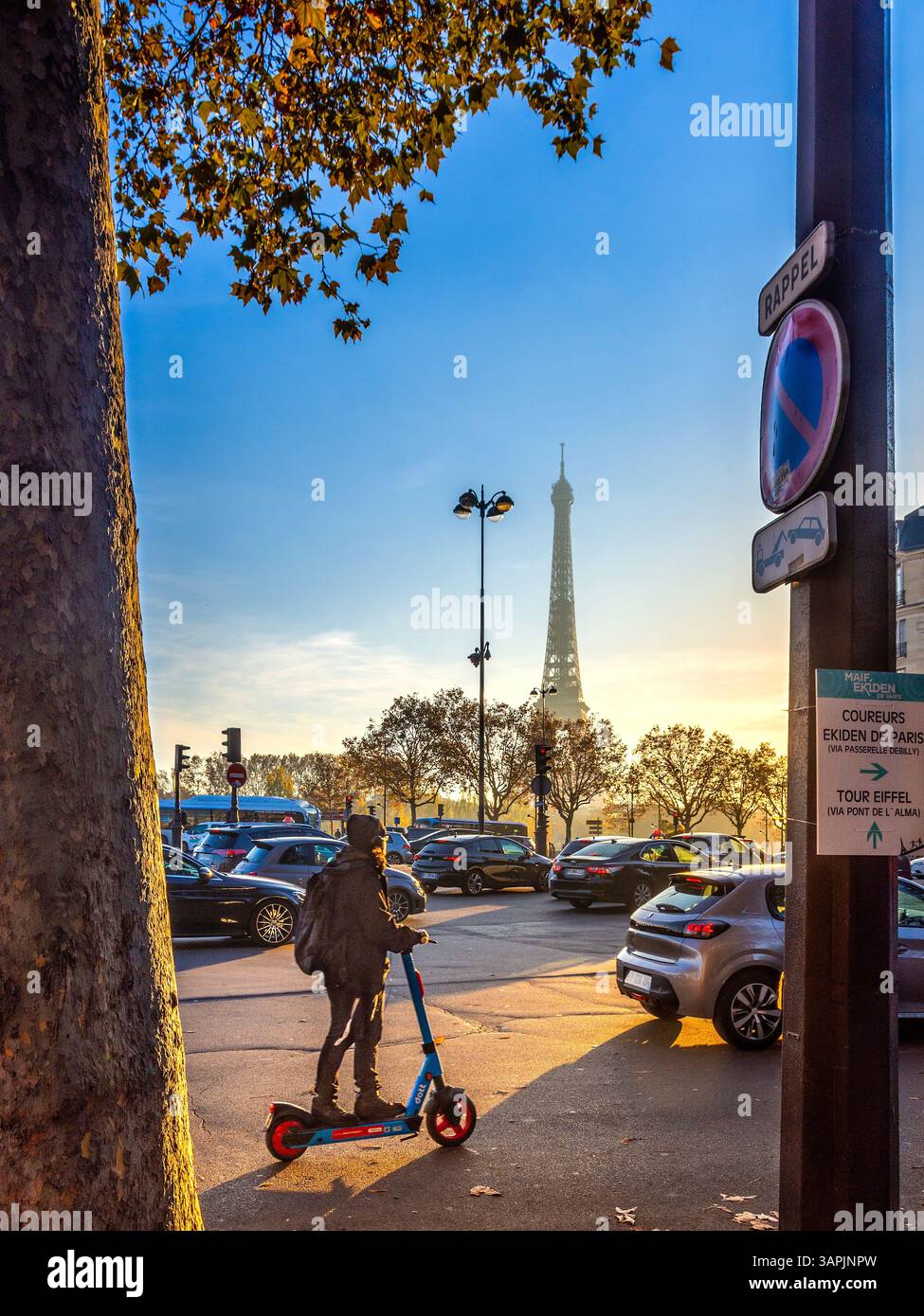 Evening traffic heading west from the city center with the Eiffel Tower ...
