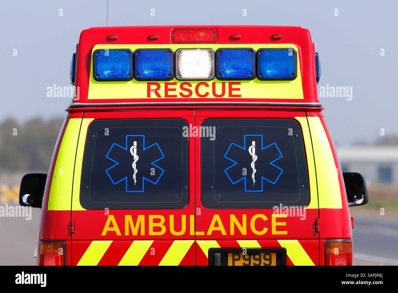 close up of blue lights on the rear of a private ambulance at a ...