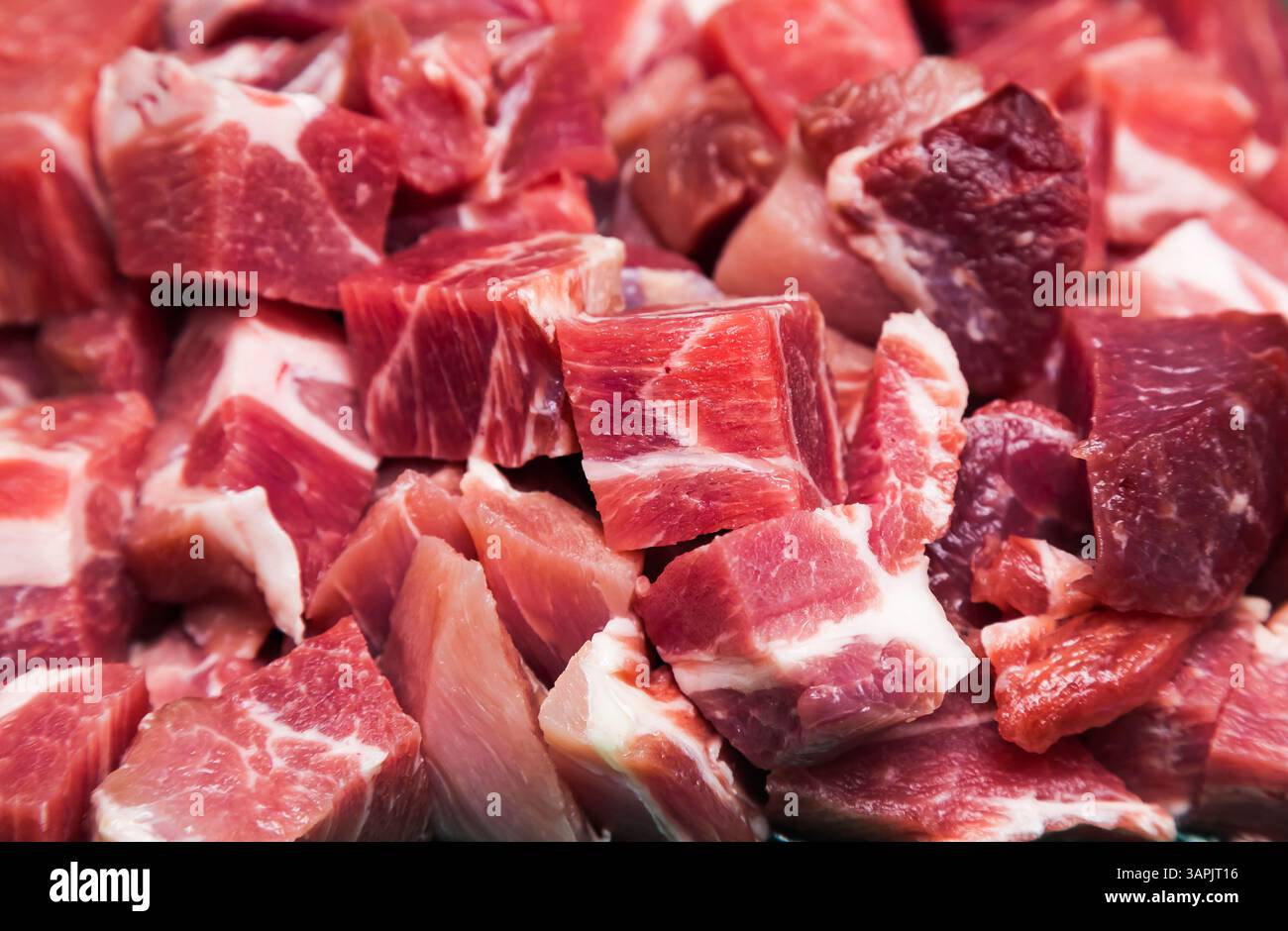 Heap of fresh meat diced, close-up. Sliced meat with layers of fat ...
