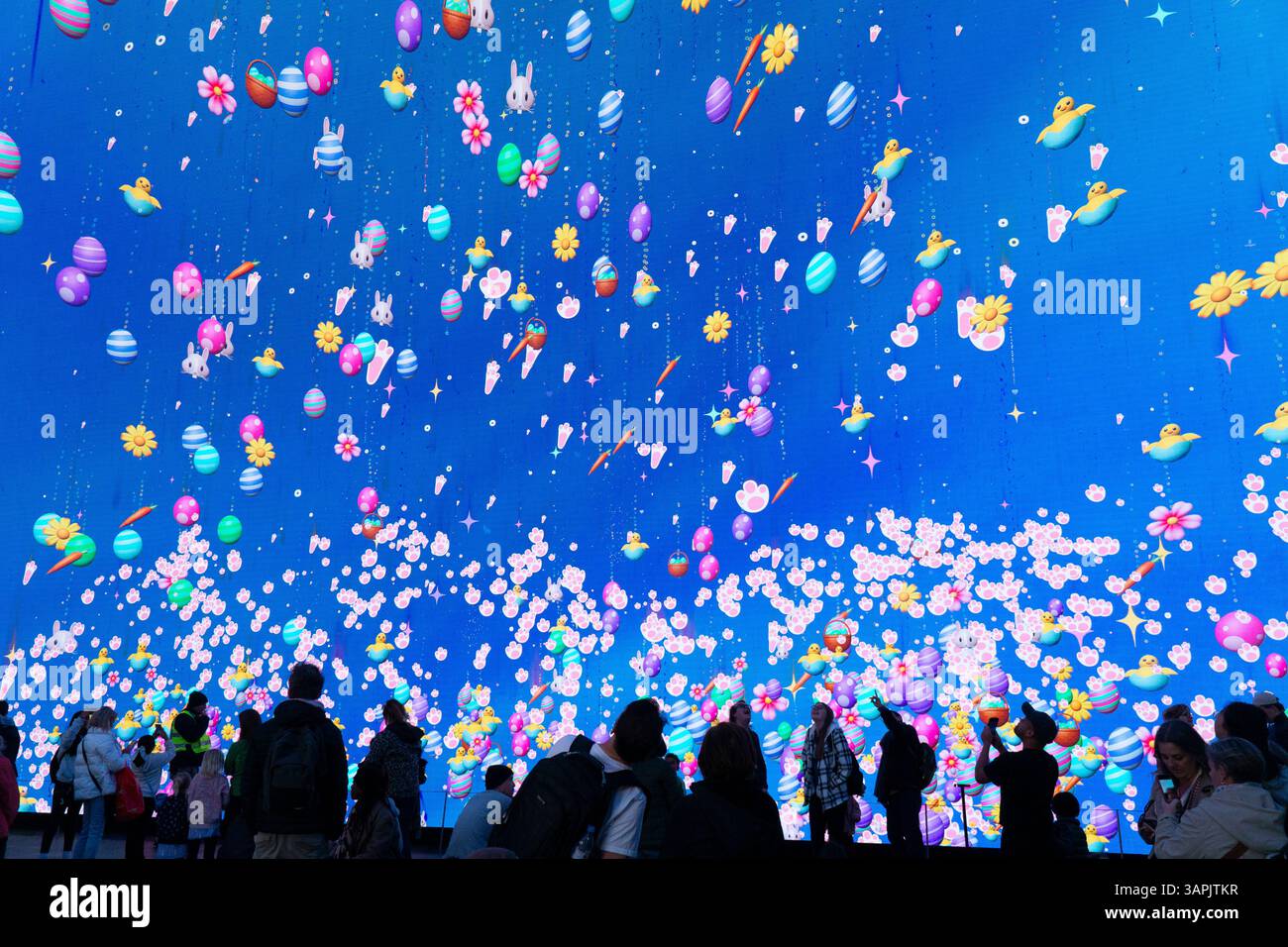 London, UK. 16th Apr, 2025. tourists watch animated displays on giant ...
