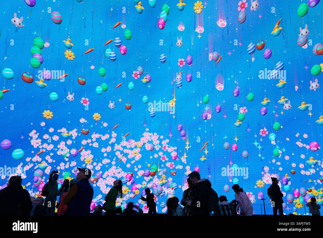 London, UK. 16th Apr, 2025. tourists watch animated displays on giant ...
