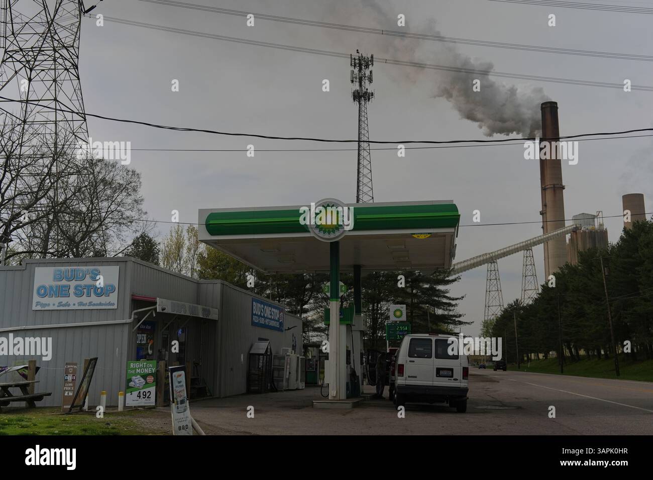 A motorist pumps gas near the Gen. James Gavin Power Plant, a coal ...