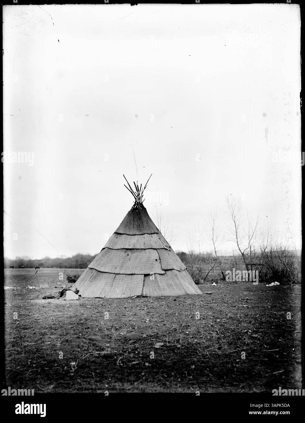This image captures a tipi set against a vast landscape, showcasing the ...