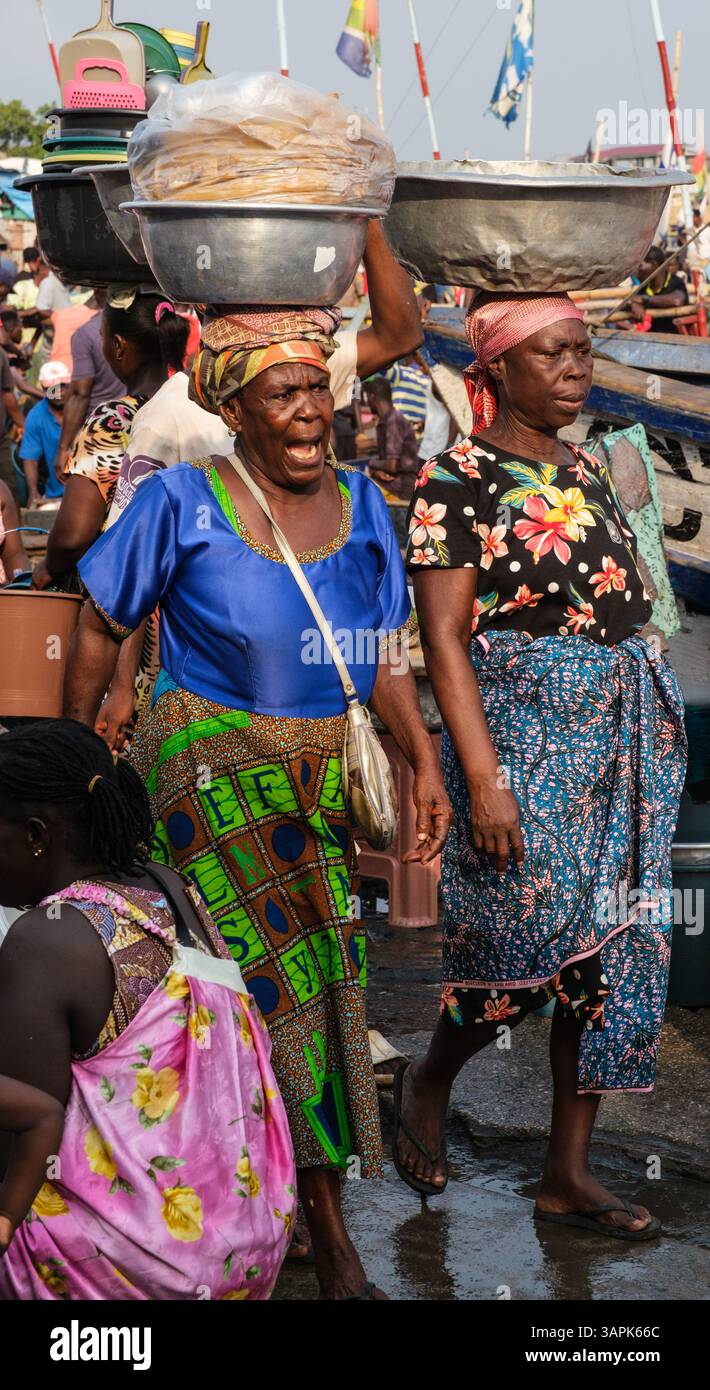 Ghana, Elmina. Women Vendors in the Fish Market, Carrying Goods on ...