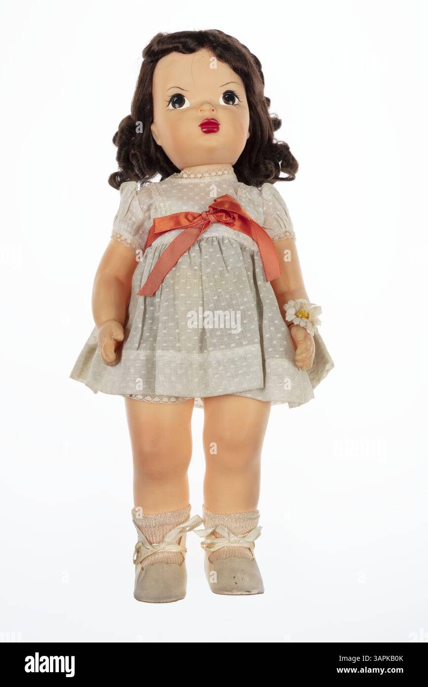 This plastic doll by Terri Lee Company features dark brown hair, a ...