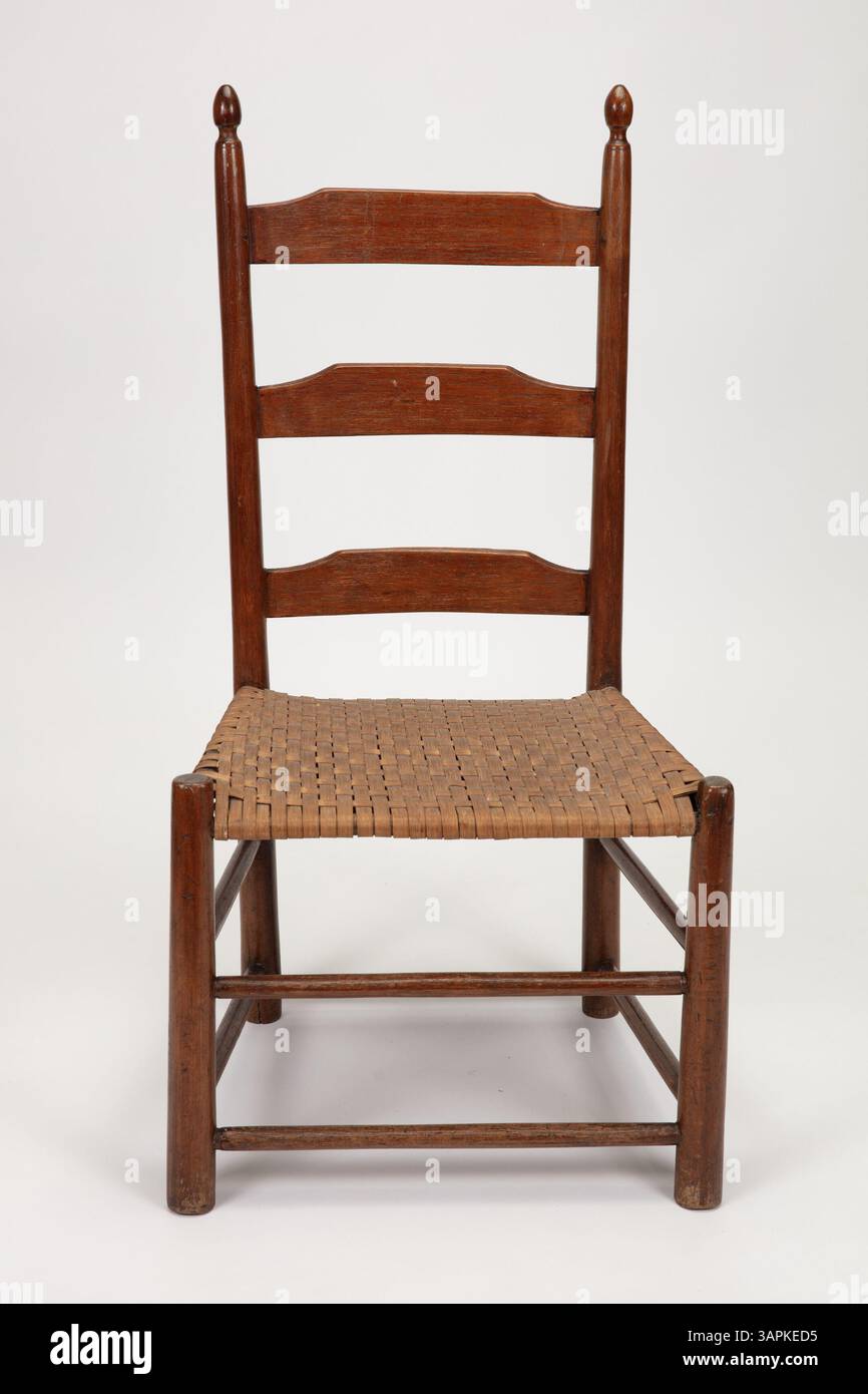 This slat-back side chair, made from wood and featuring a woven hickory ...
