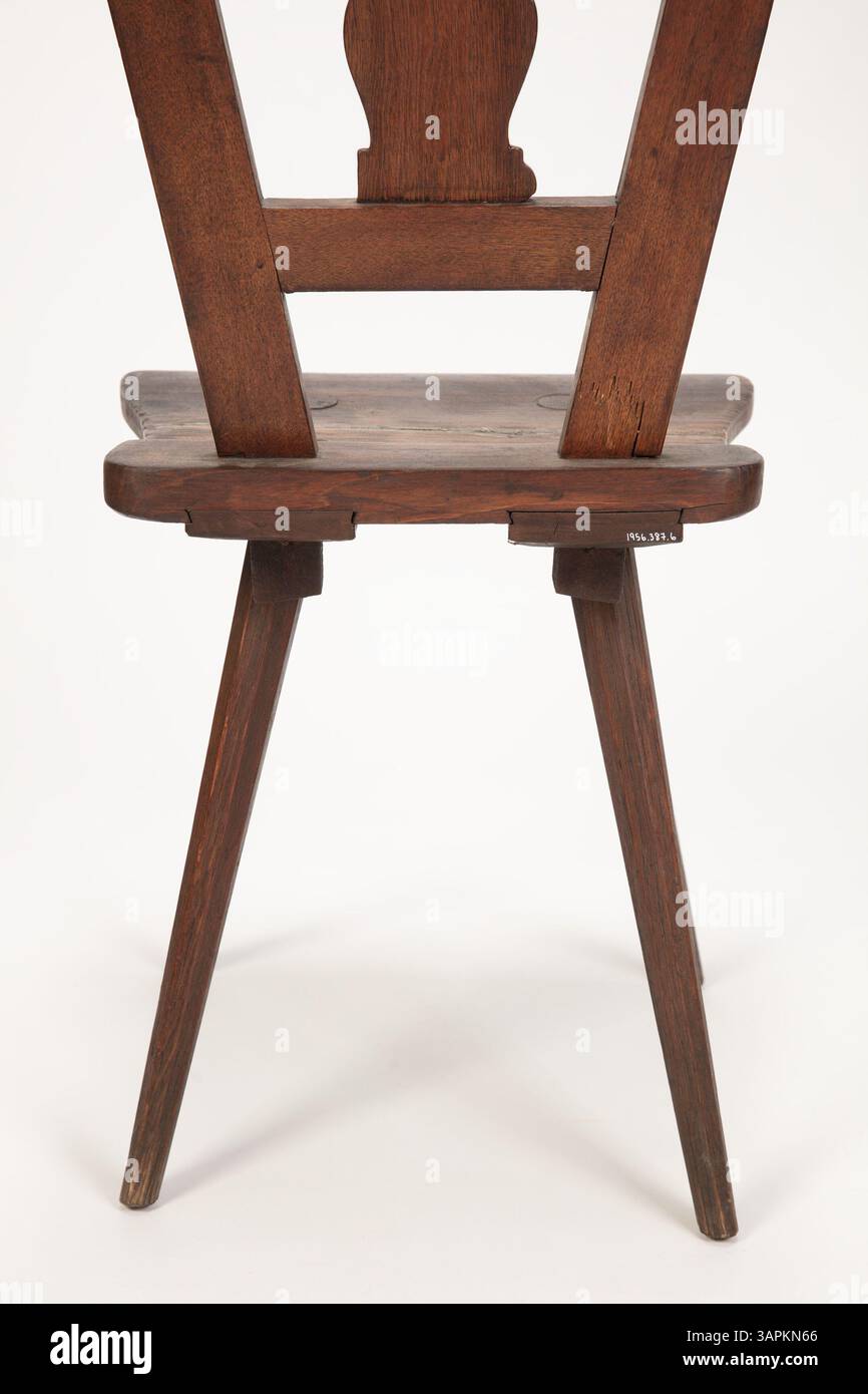 This German Alpine style side chair, crafted from walnut, features peg ...