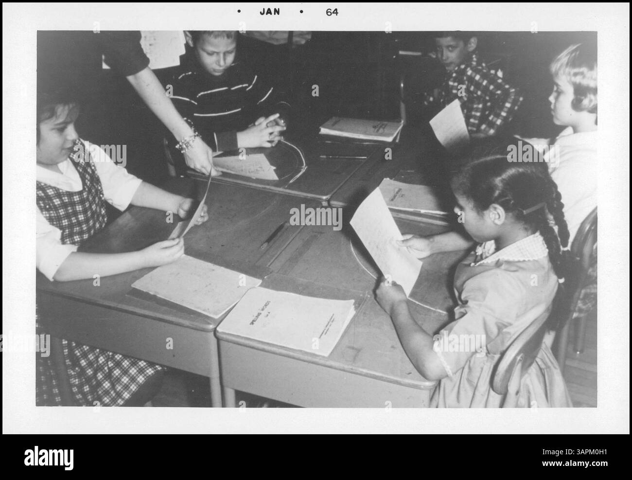This 1964 photo, stamped January, 1964, shows a group involved in word ...