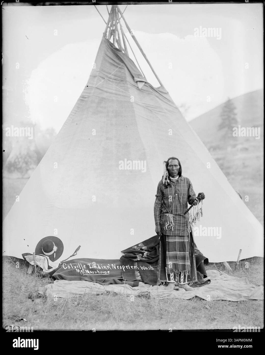 Photograph of Colville Indians in regalia, holding ceremonial objects ...