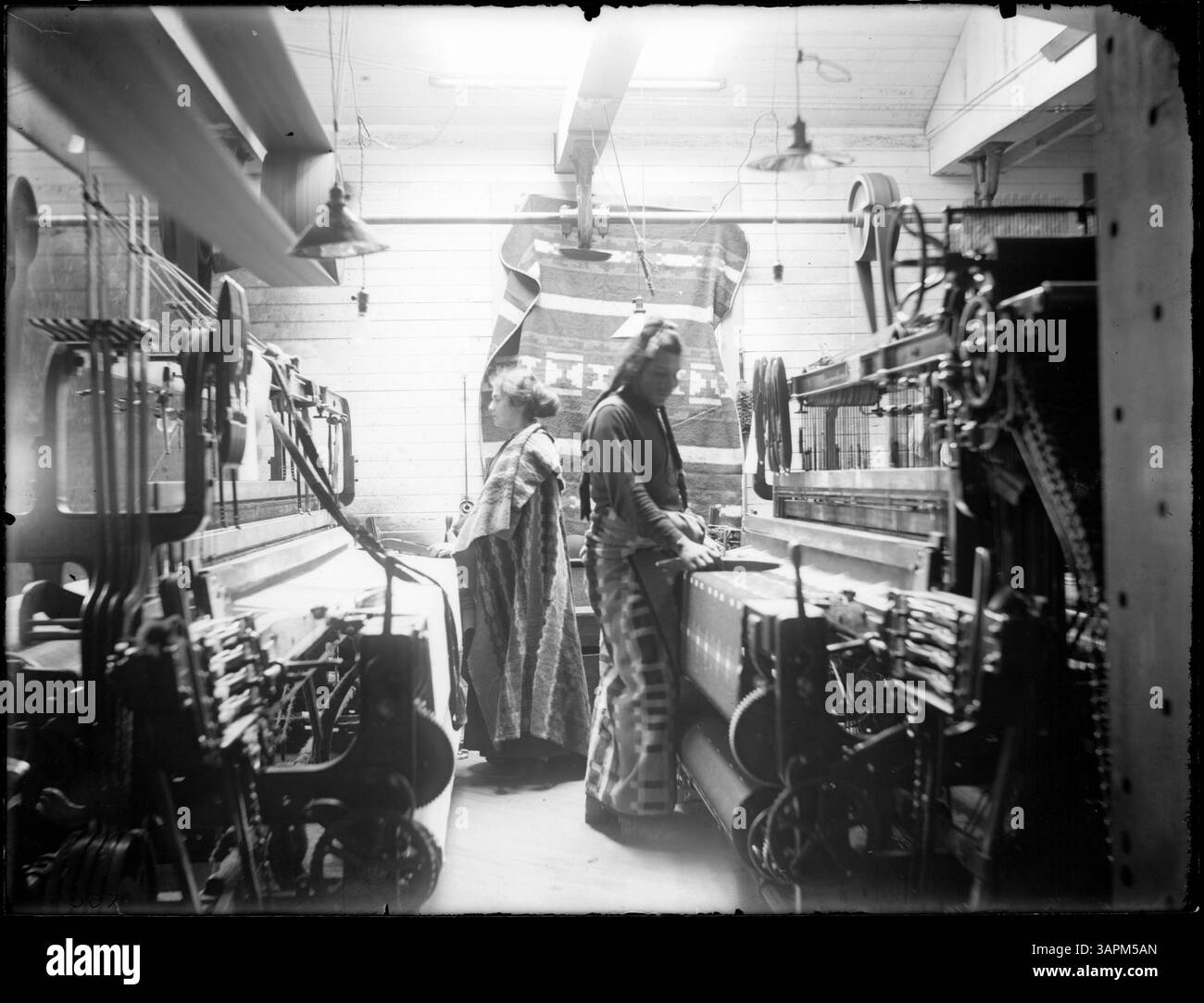 This photograph depicts Native Americans working looms at the Pendleton ...