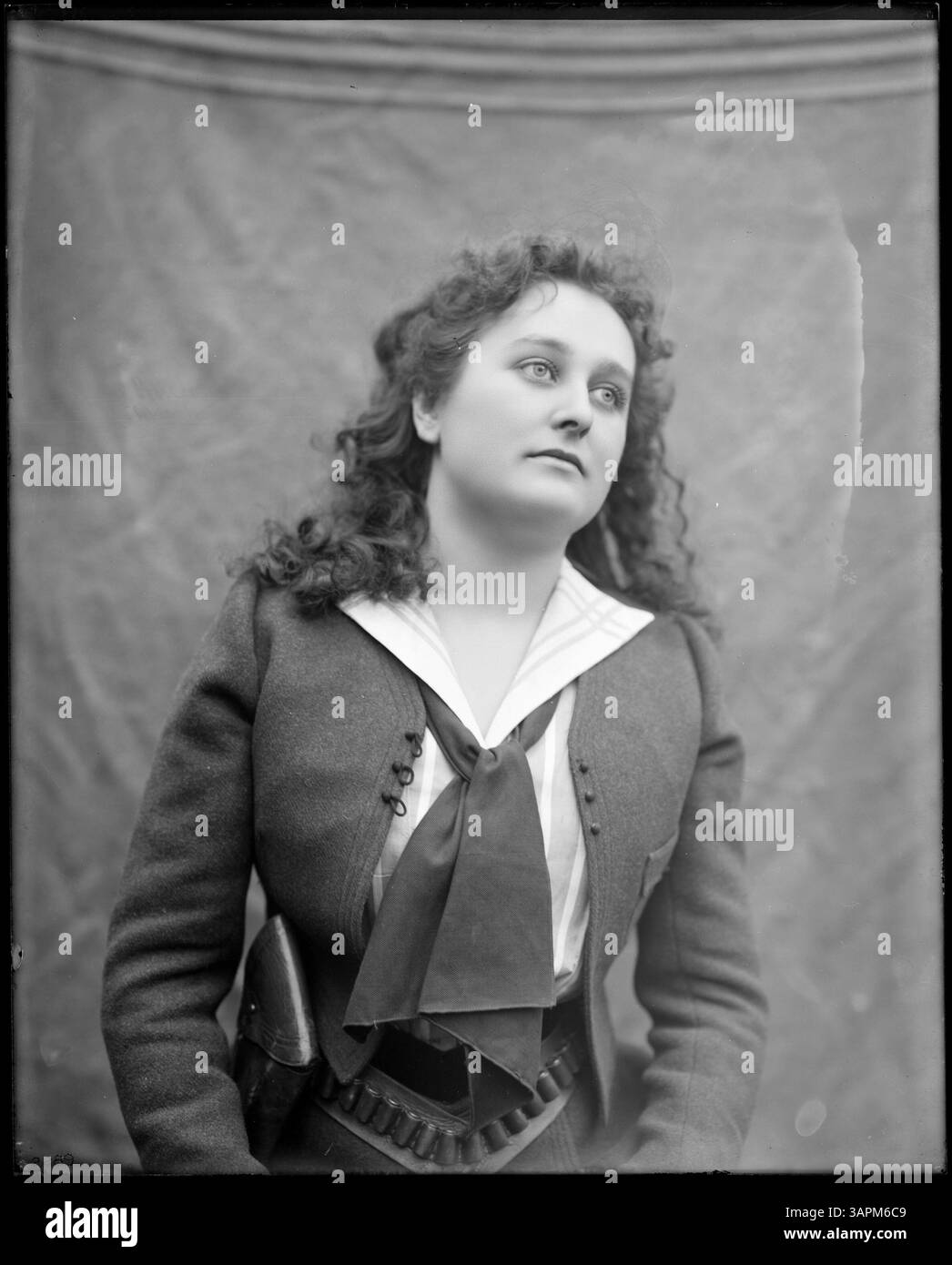 A photograph by Lee Moorhouse depicting Alice Archer dressed in a ...
