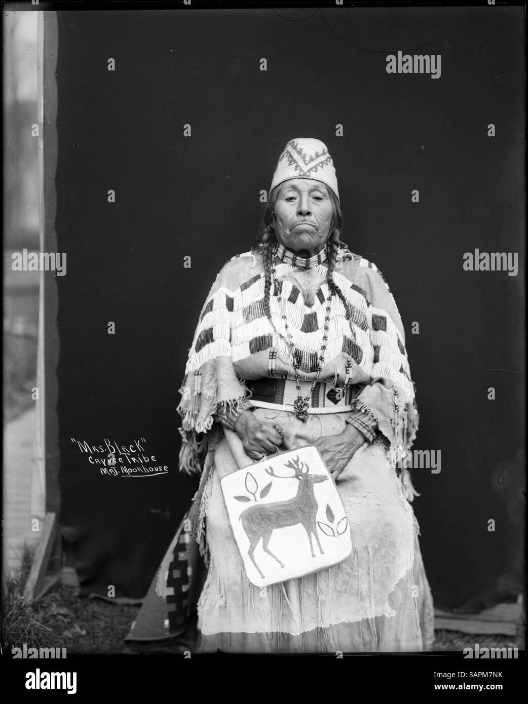 This photograph depicts Mrs. Black, an elderly Cayuse woman, showcasing ...