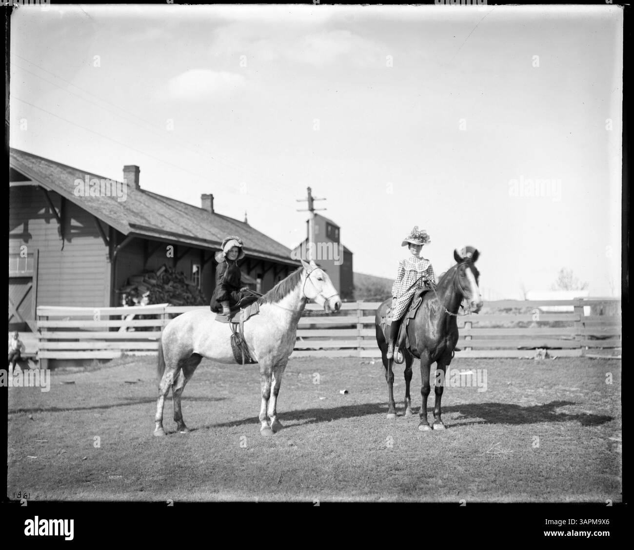 The 1961 photograph by Lee Moorhouse shows two women on horseback, one ...