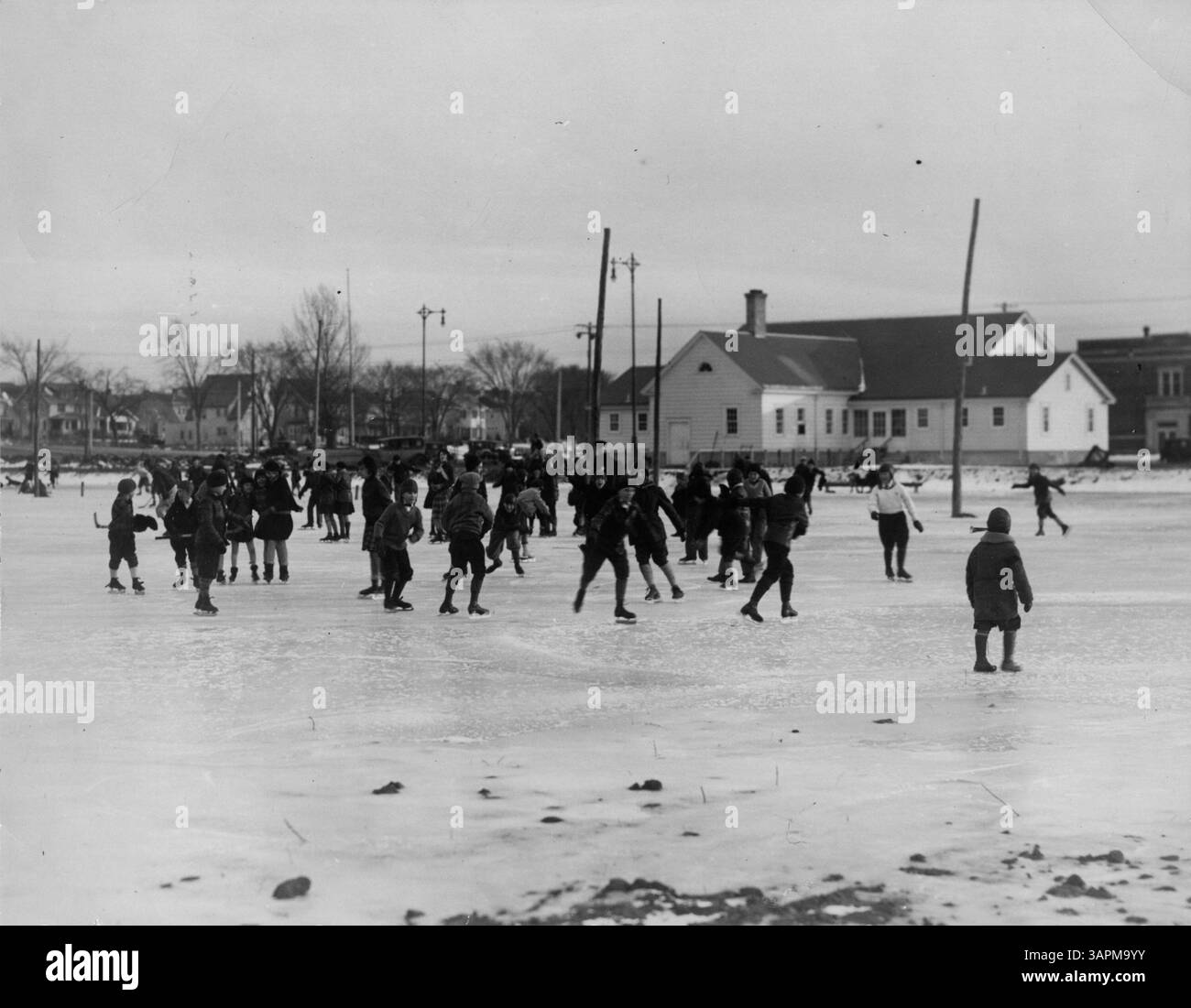 This photograph from December 23, 1928, shows a group of children ice ...