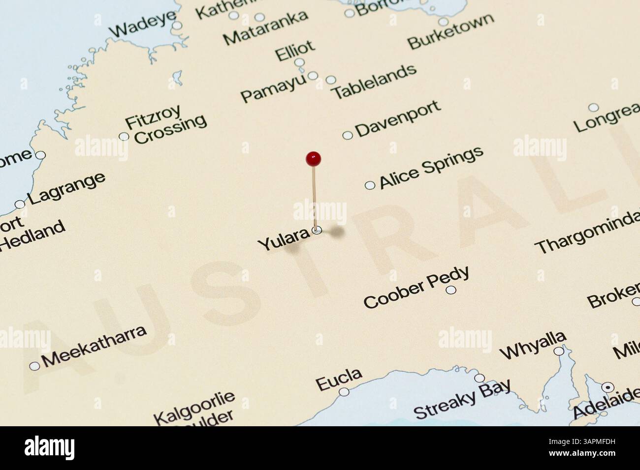 macro photo of a red pin needle into Yulara city of Australia political ...
