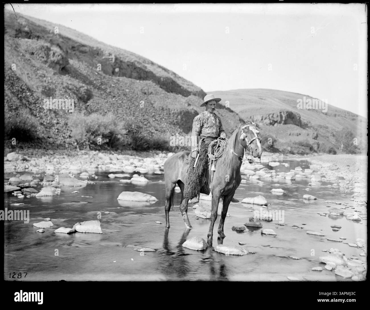 This photograph by Lee Moorhouse shows Munshang the cowboy on horseback ...