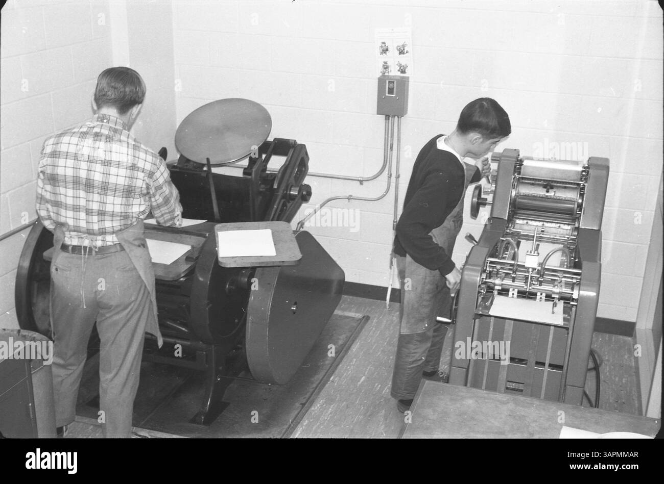The 1965 photograph depicts students learning typesetting and printing ...
