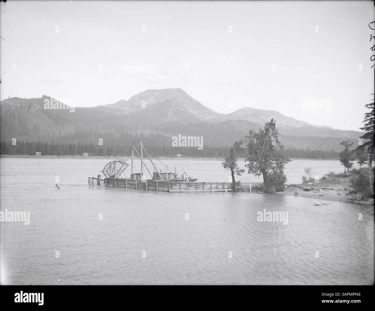 This black and white photograph depicts a fish wheel along the Columbia ...