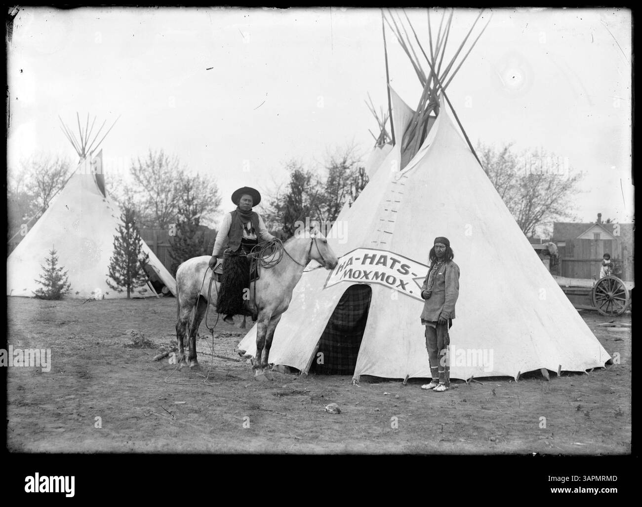 Photograph of a tipi with a man on horseback and another standing, with ...