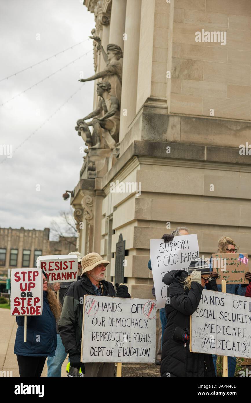 BLOOMINGTON, INDIANA – APRIL 15: Demonstrators holding signs under the ...