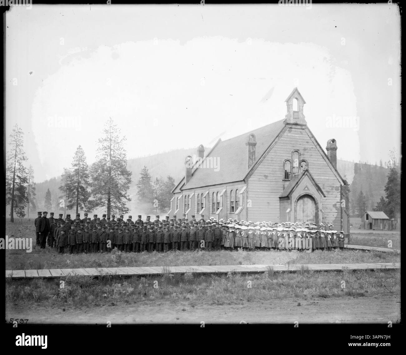 This black and white photograph from 1903 shows students and teachers ...