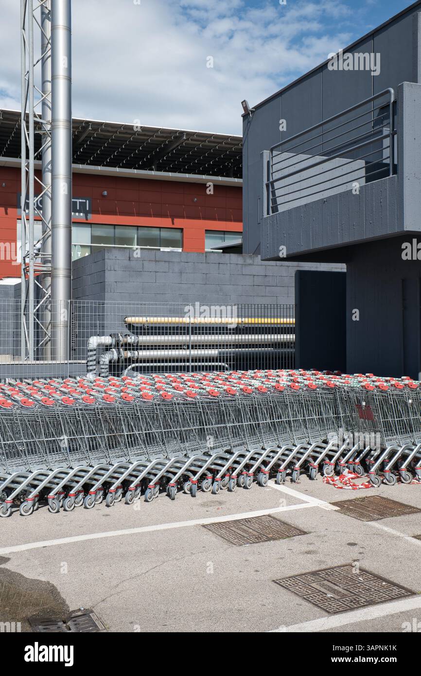 long line of carts in the backyard of a supermarket in Siena, Italy ...