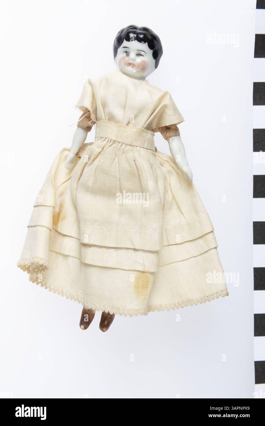 A China doll in a white cotton dress, part of the Missouri Historical ...