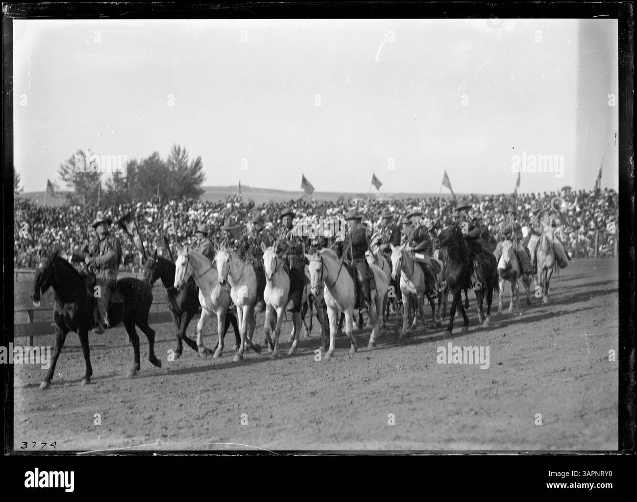 The photograph shows a mounted cowboy band, with cowboys playing ...