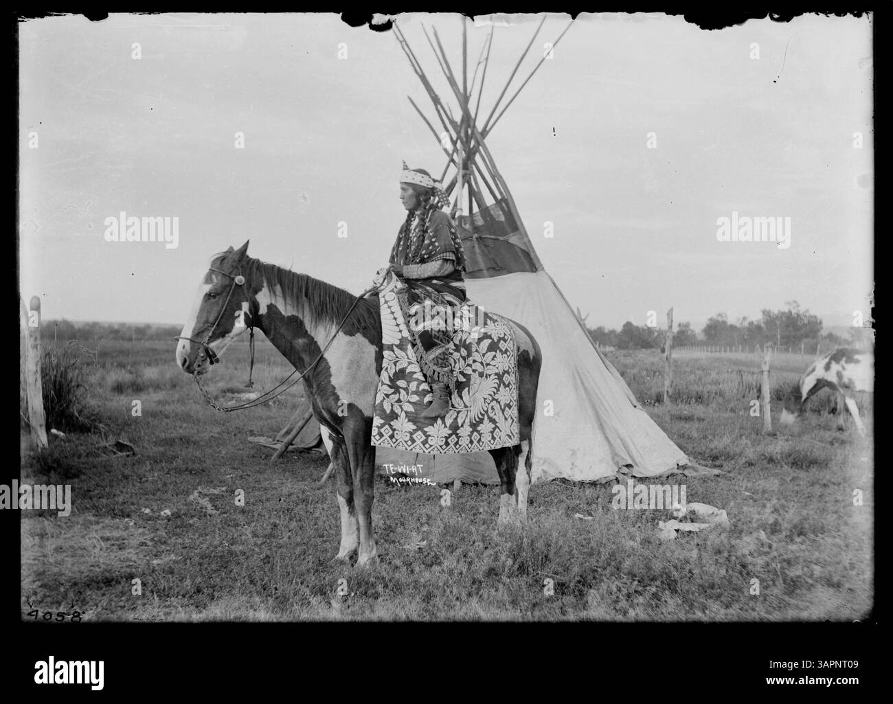 The photograph shows Ti-we-at, a Yakima tribal woman, dressed in ...