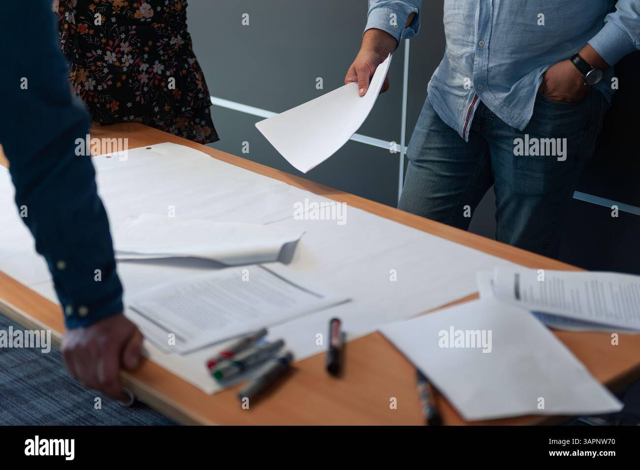 Business Meeting: Team Collaborating with Documents Stock Photo - Alamy