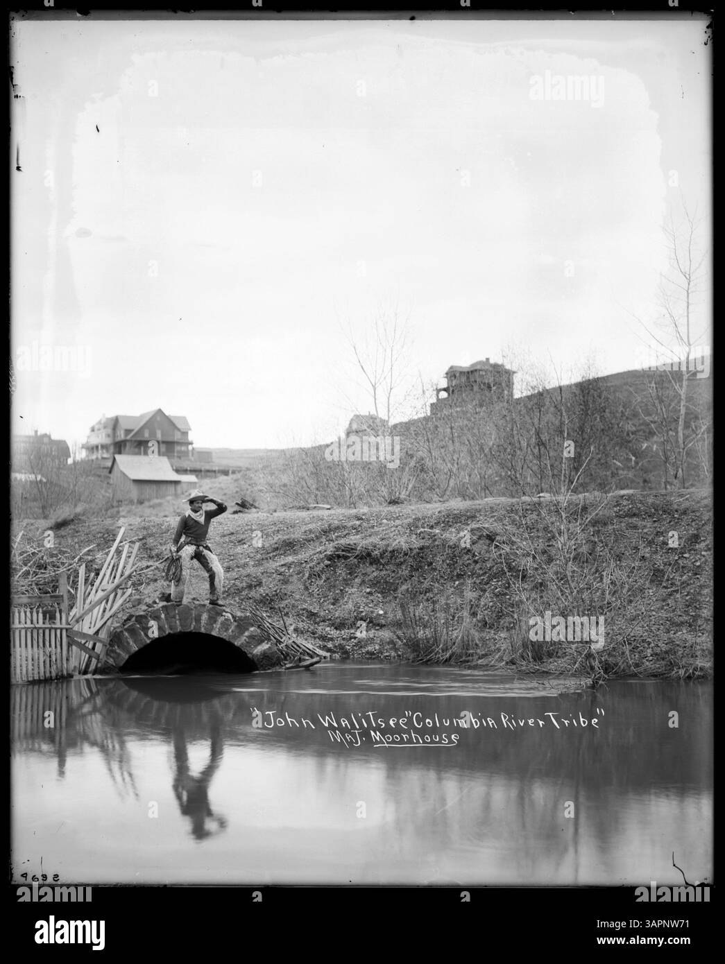 Photograph of John Walitsee, a Columbia River Indian, standing on a ...