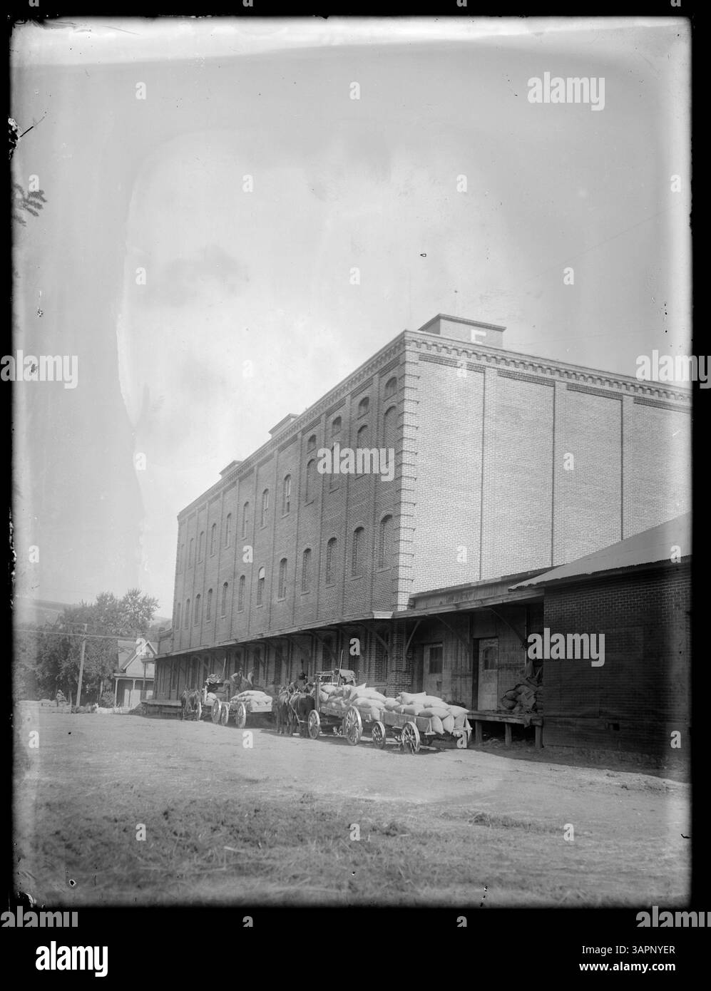 This photograph by Lee Moorhouse shows the unloading of wheat sacks at ...