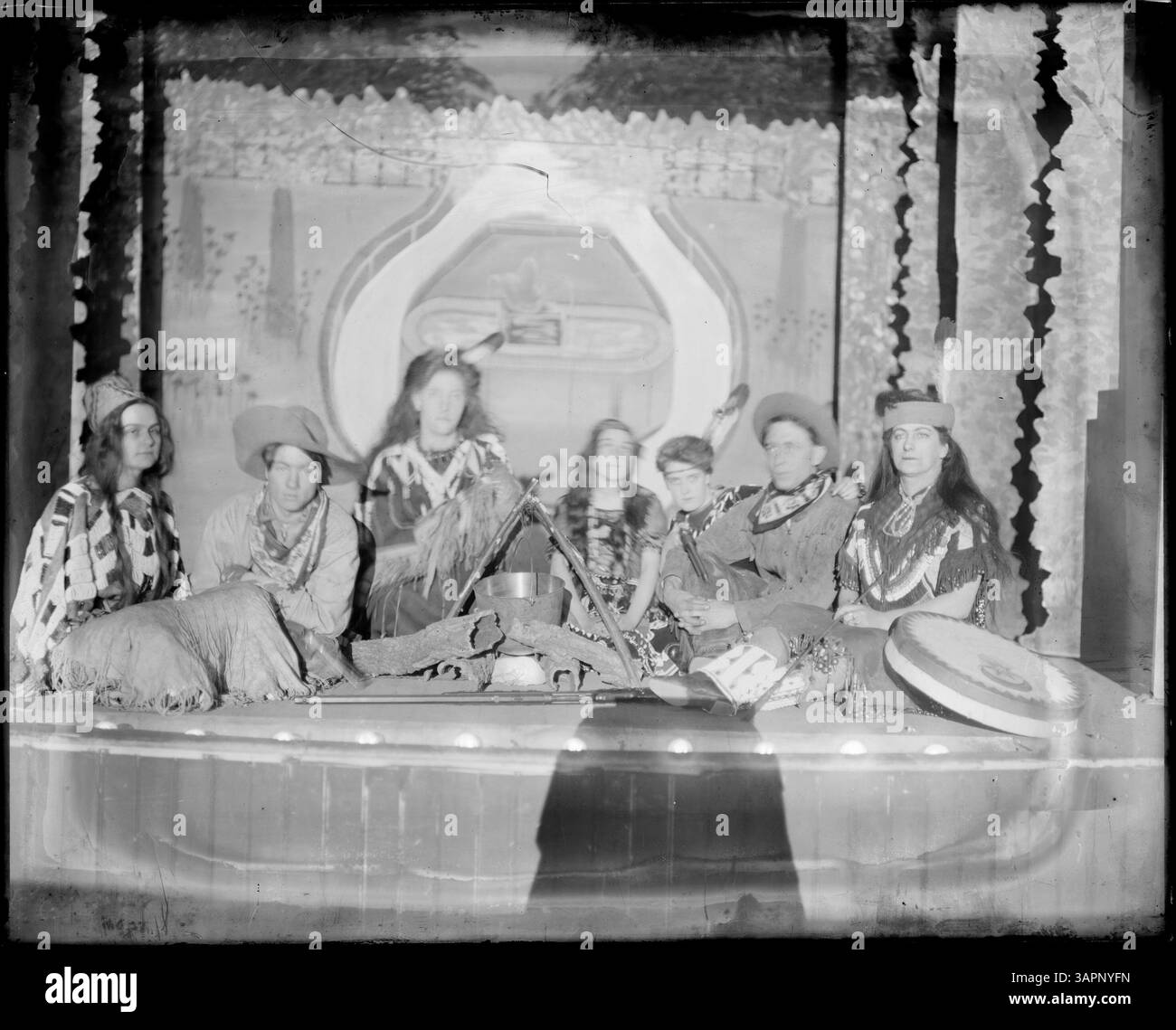 This image depicts a tableau of cowboys and women dressed as Native ...