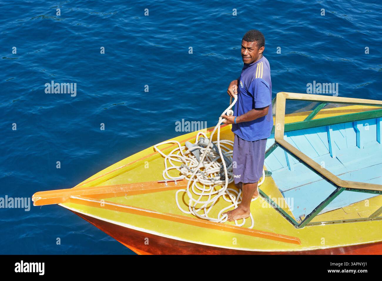Local man mooring shuttle boat for Yasawa Flyer, Yasawa island group ...