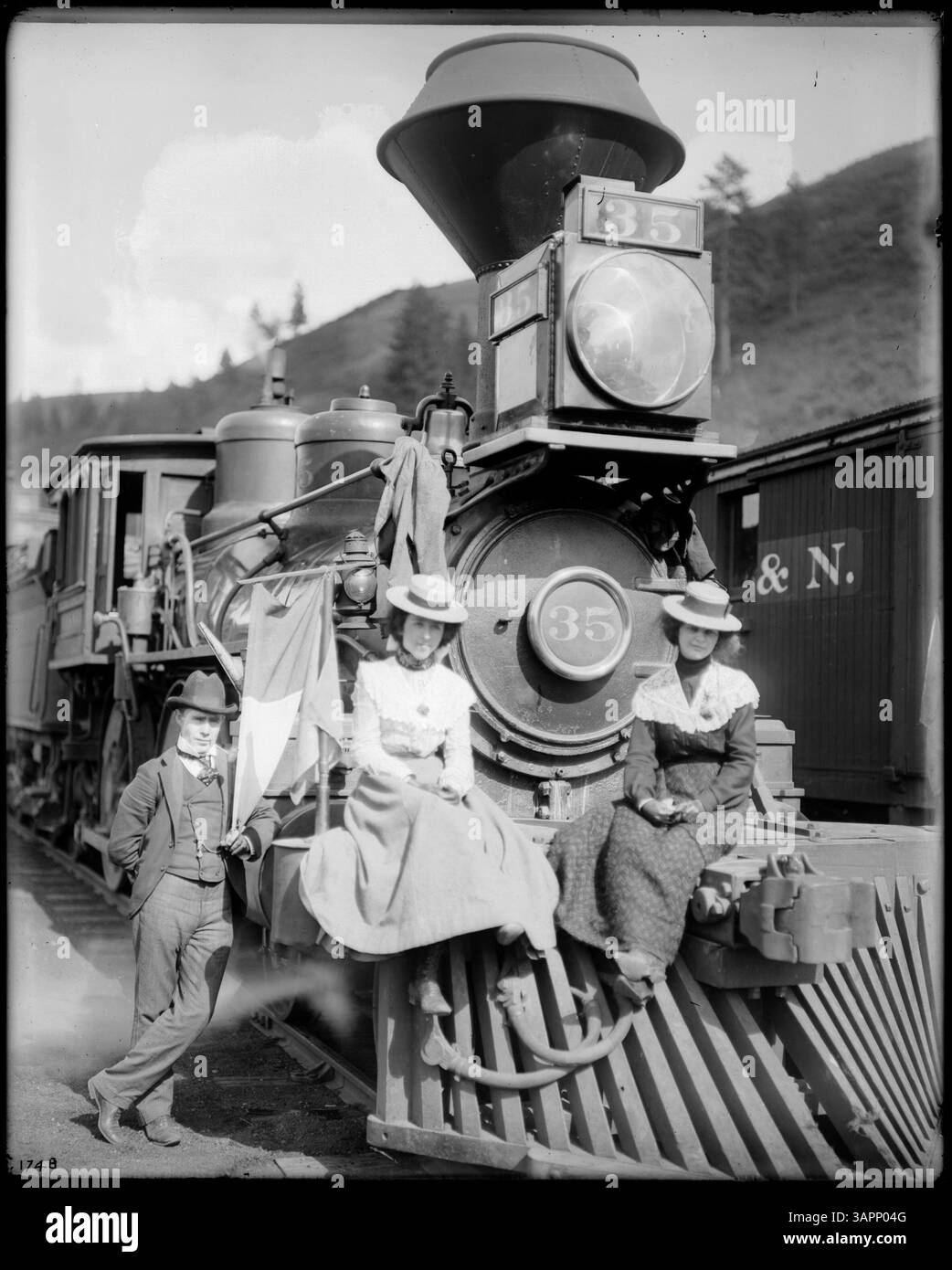 The photograph shows O.R.N. engine no. 35 with two women positioned on ...