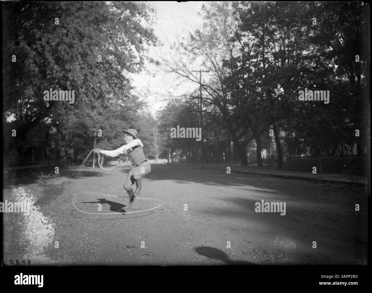 L.E. McCoy is captured performing trick roping, a popular Western skill ...