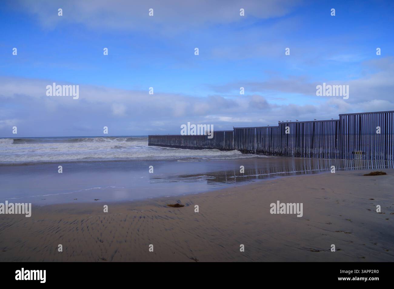 The Mexico and United States border wall extends onto the Pacific Ocean ...