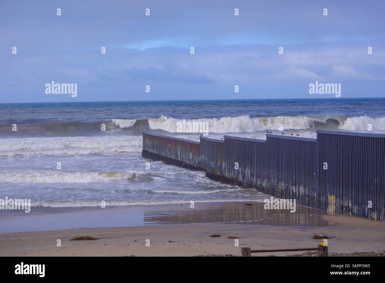 Border wall slices through Tijuana beach into the Pacific, in Mexico ...
