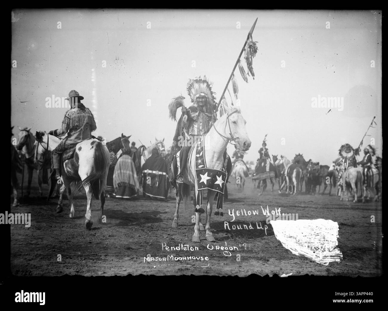 Yellow Wolf, a Native American man, is seated on a white horse holding ...