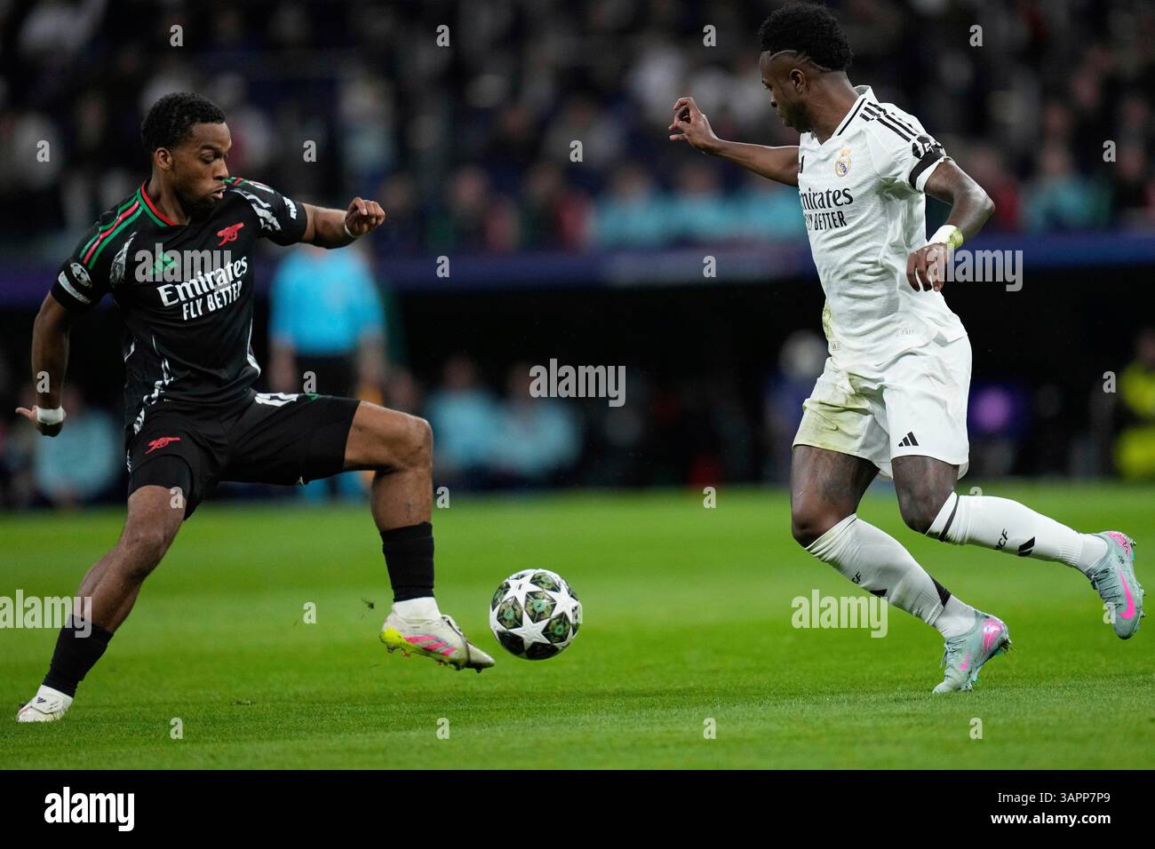 Arsenal's Jurrien Timber, left, duels for the ball with Real Madrid's ...
