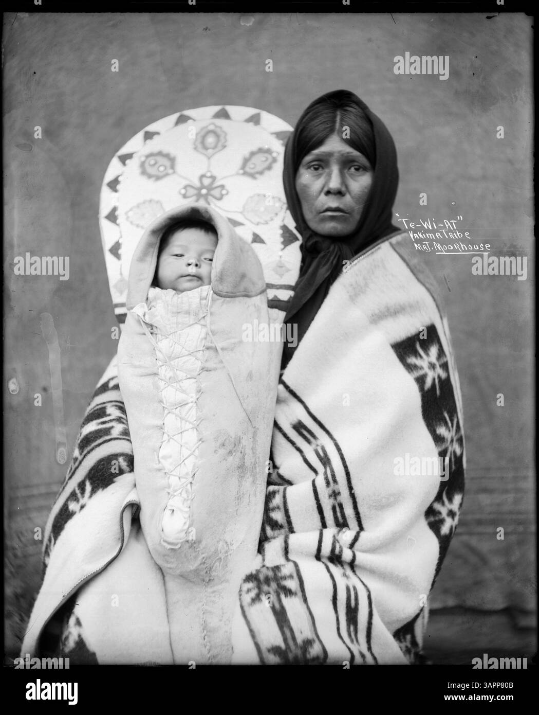 Ti-we-at, a Yakima tribal woman, is pictured with an infant in a cradle ...