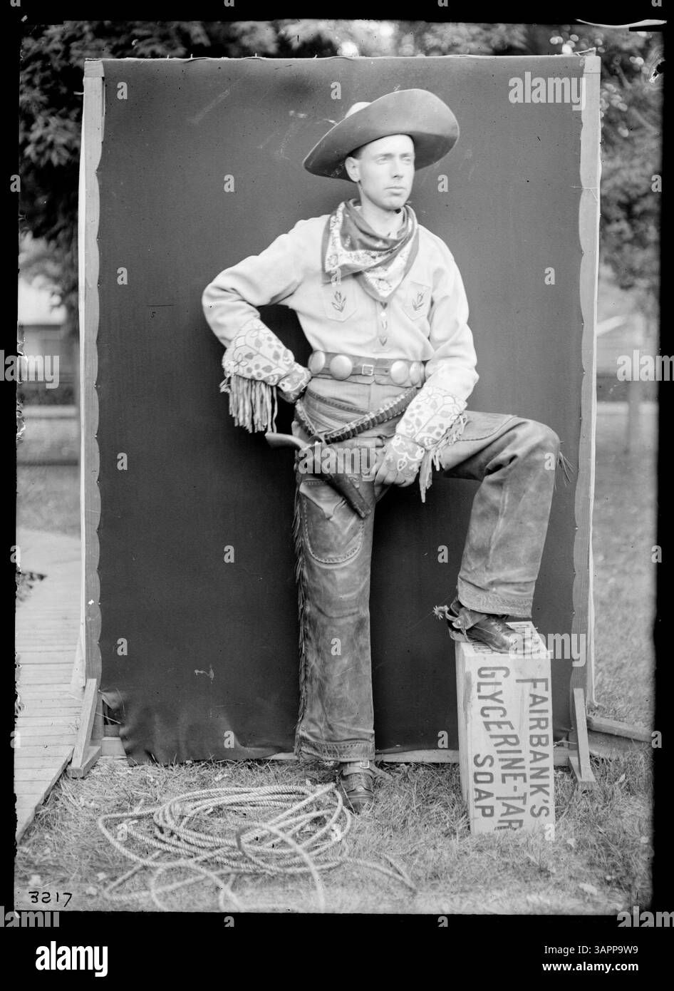 This photograph features a man in a cowboy outfit, showcasing ...