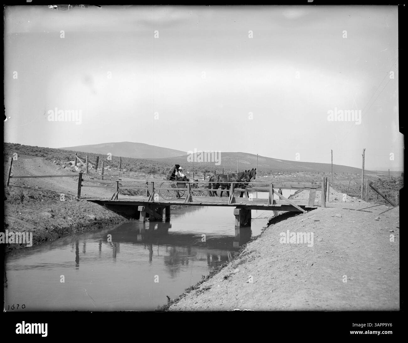 This photograph depicts the spillway and bridge over an irrigation ...