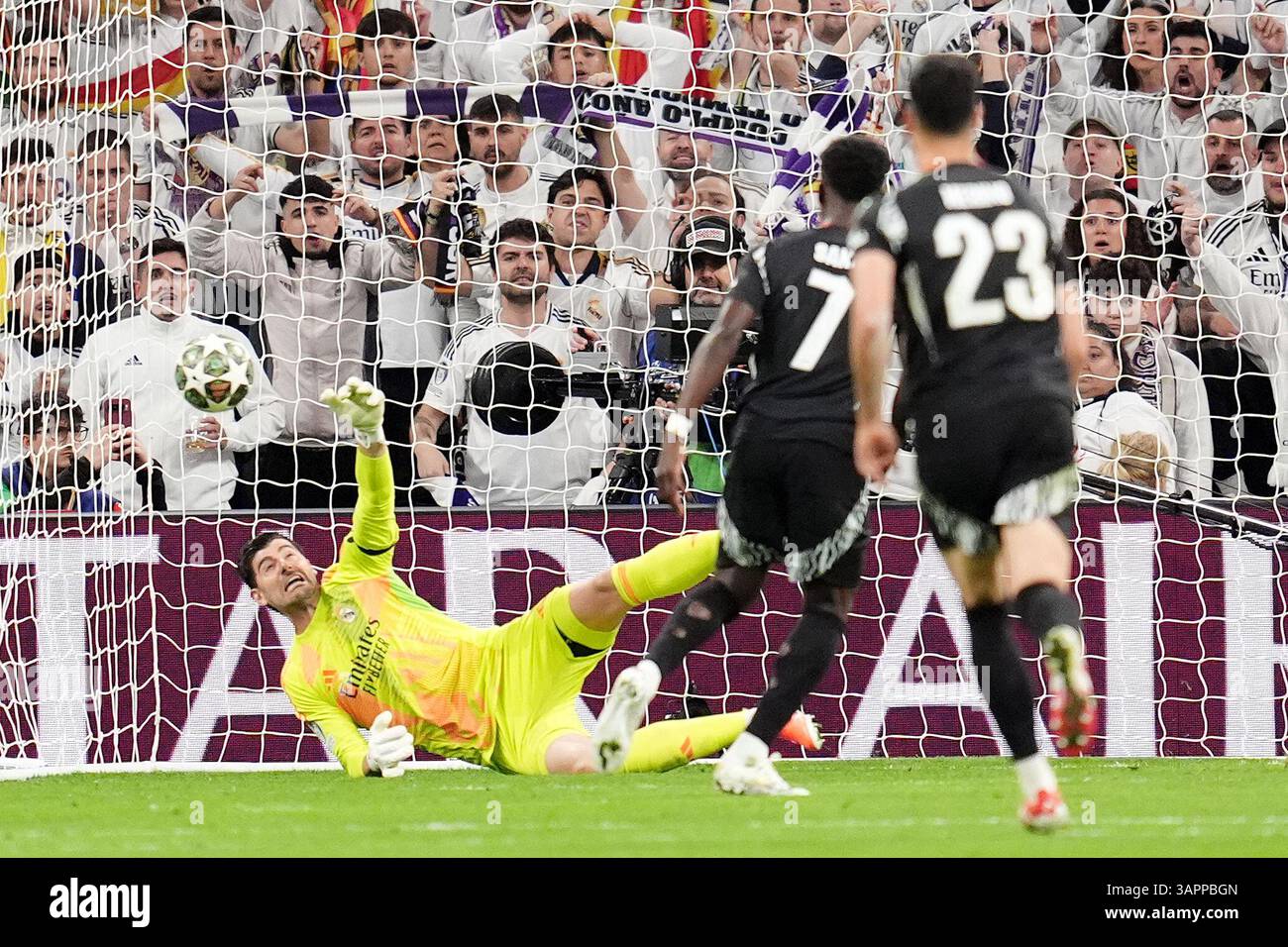 Real Madrid goalkeeper Thibaut Courtois (left) saves a penalty from ...