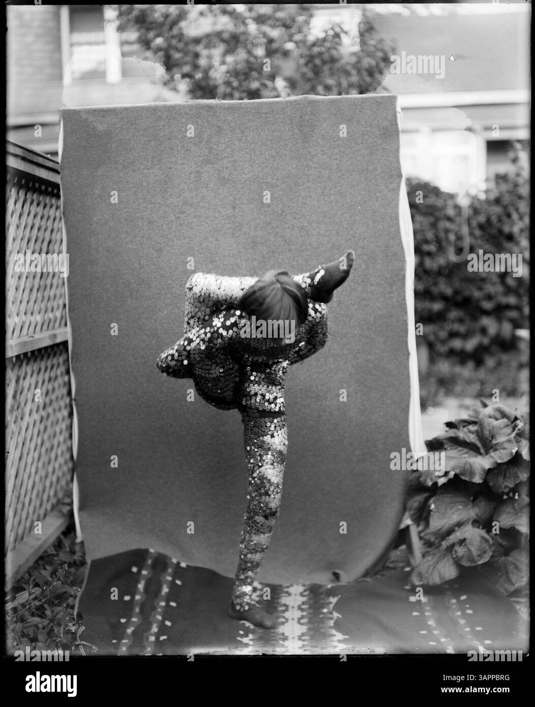 Photograph of an acrobat posed in circus attire in the Moorhouse yard ...