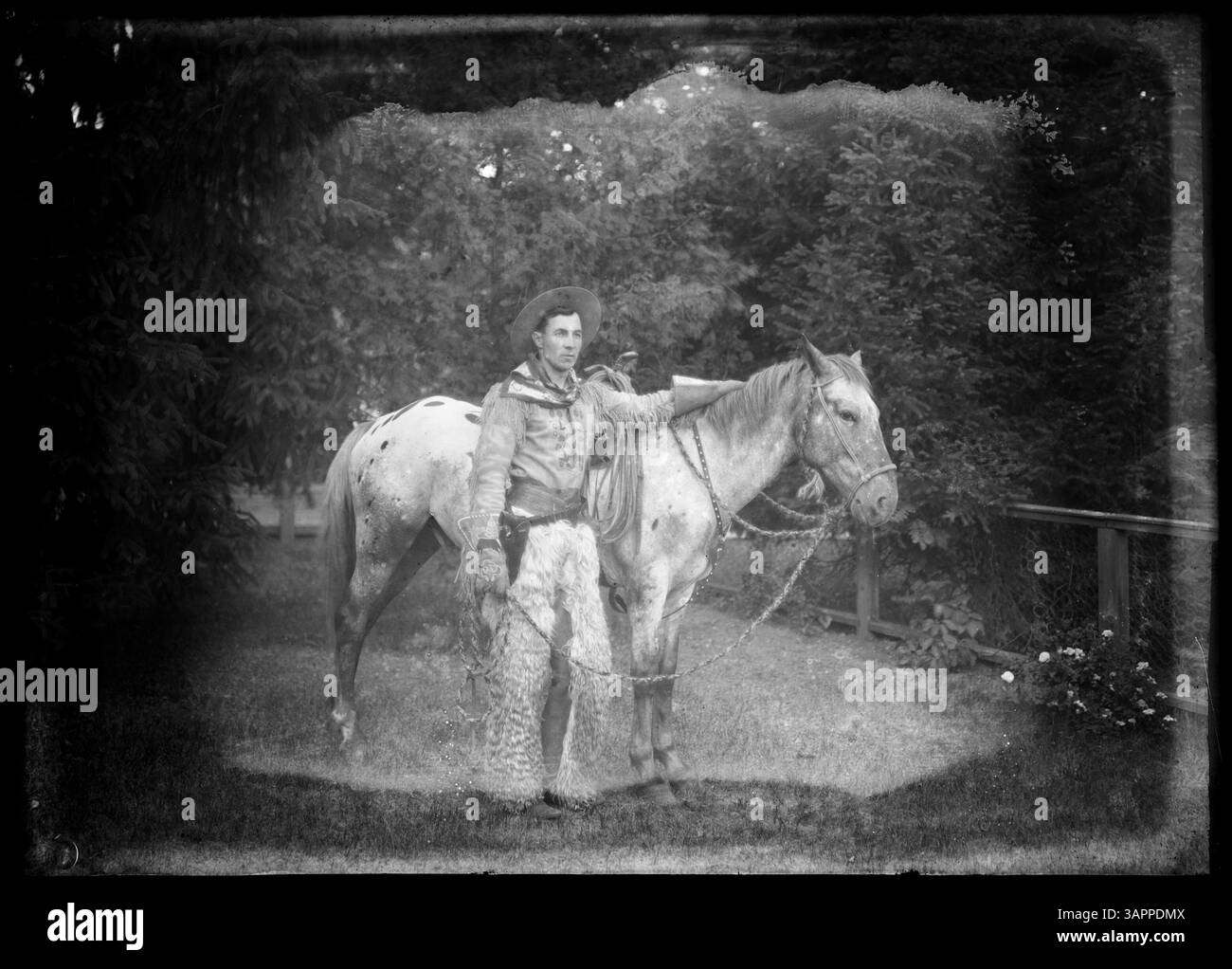 Photograph by Lee Moorhouse of a cowboy in chaps and a buckskin shirt ...