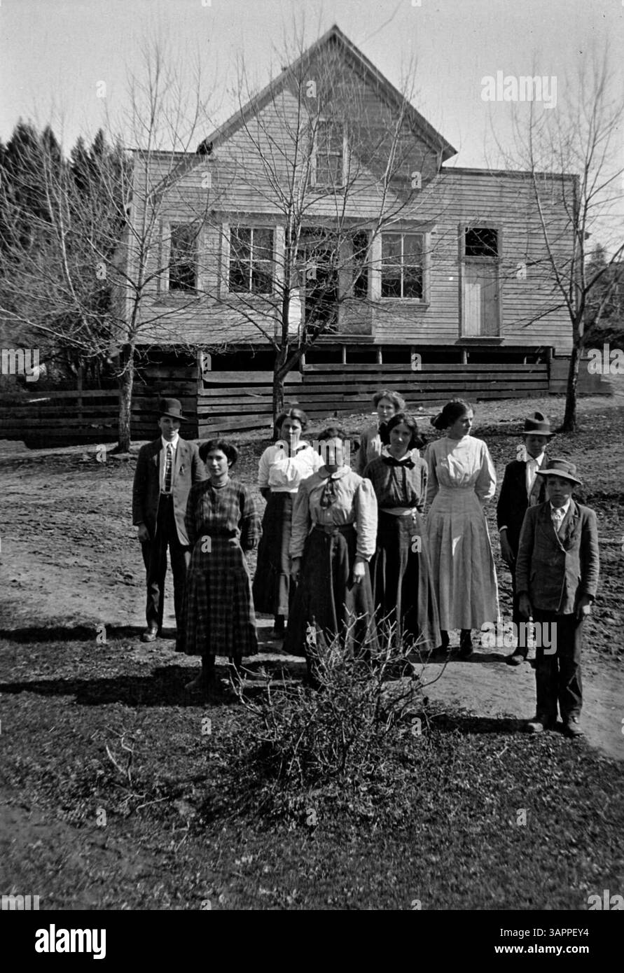A black and white photograph of nine students standing near Crow School ...