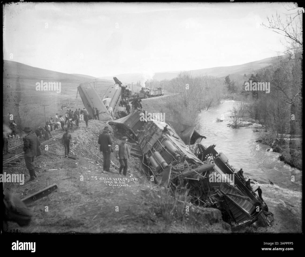 This image captures the aftermath of a train wreck, showing the damaged ...