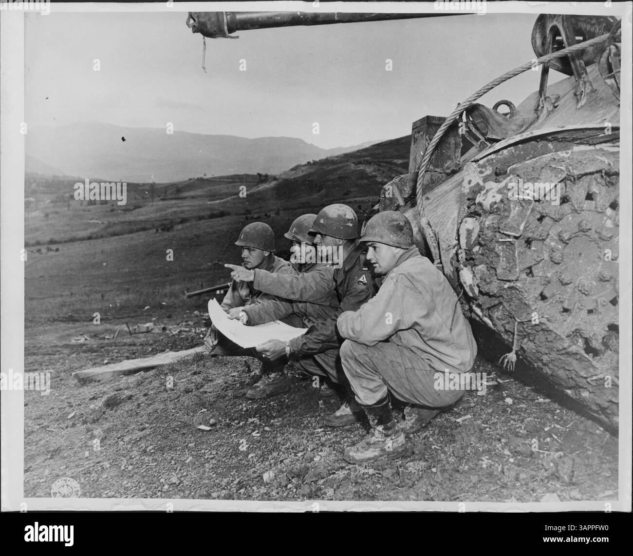 Officers from the Armored Division consult a map while stationed in ...